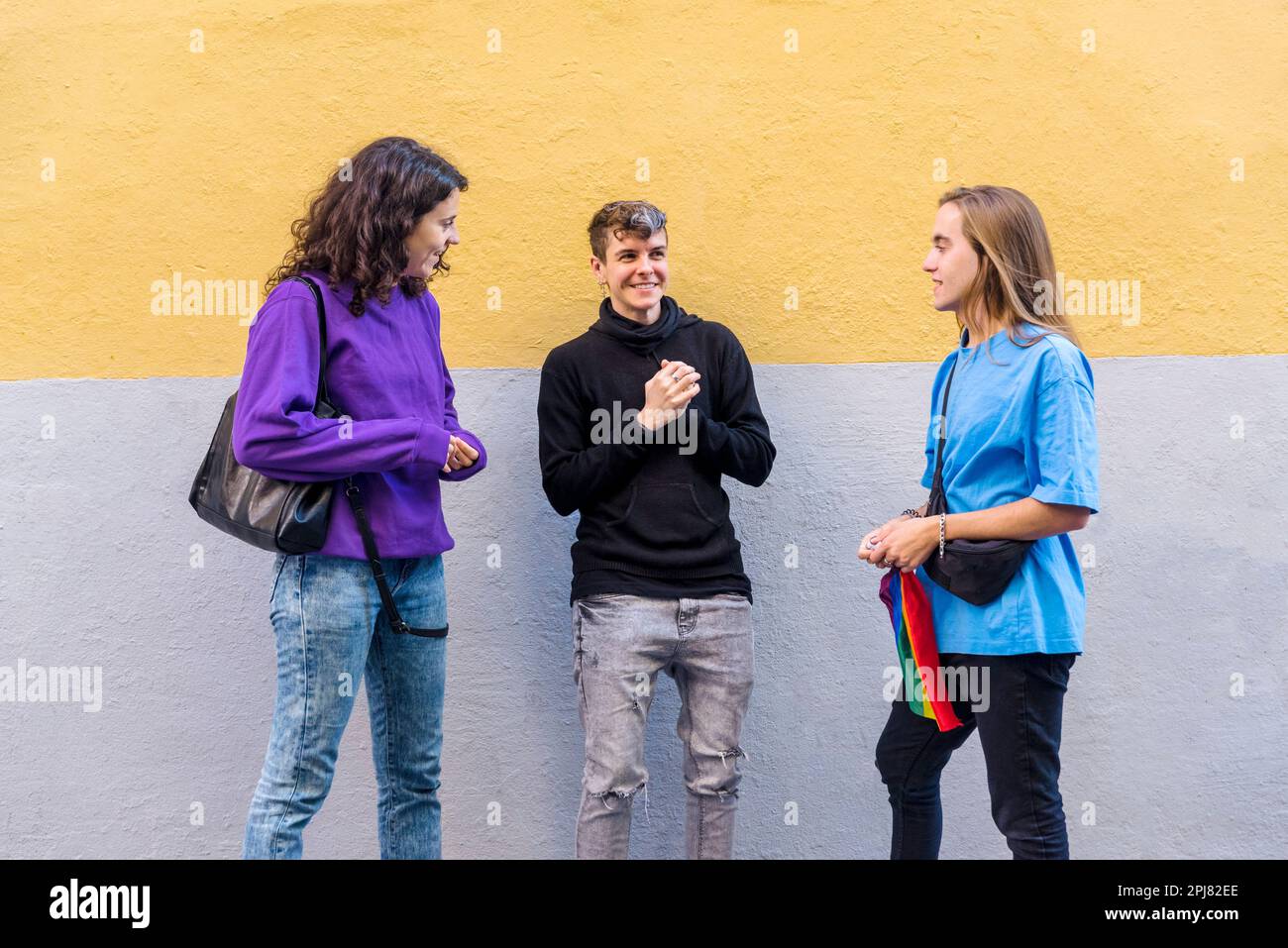 Young diverse friends talking outdoors on the street Stock Photo - Alamy