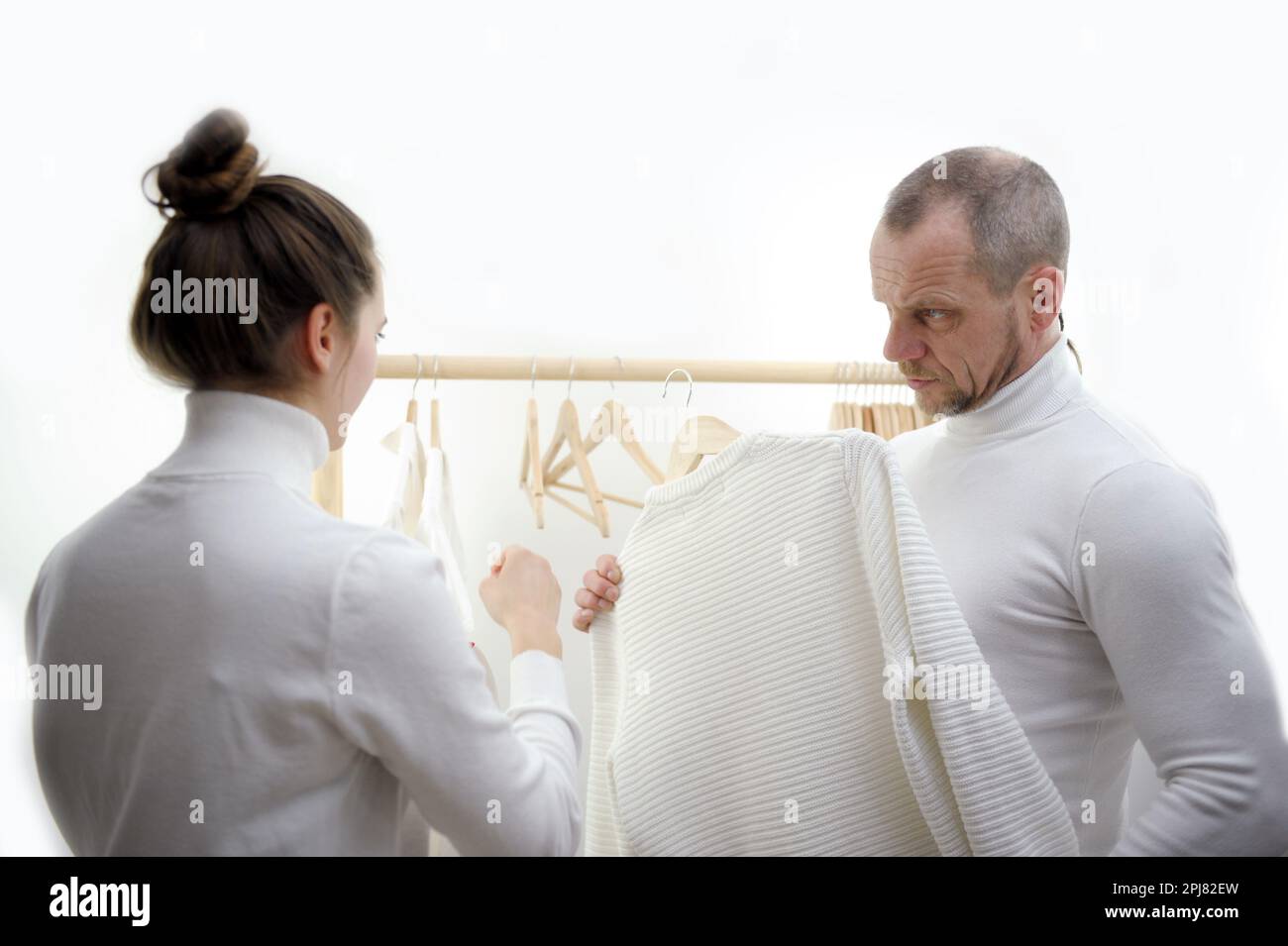 Tailor standing near male client measuring back. Tailor woman taking ...