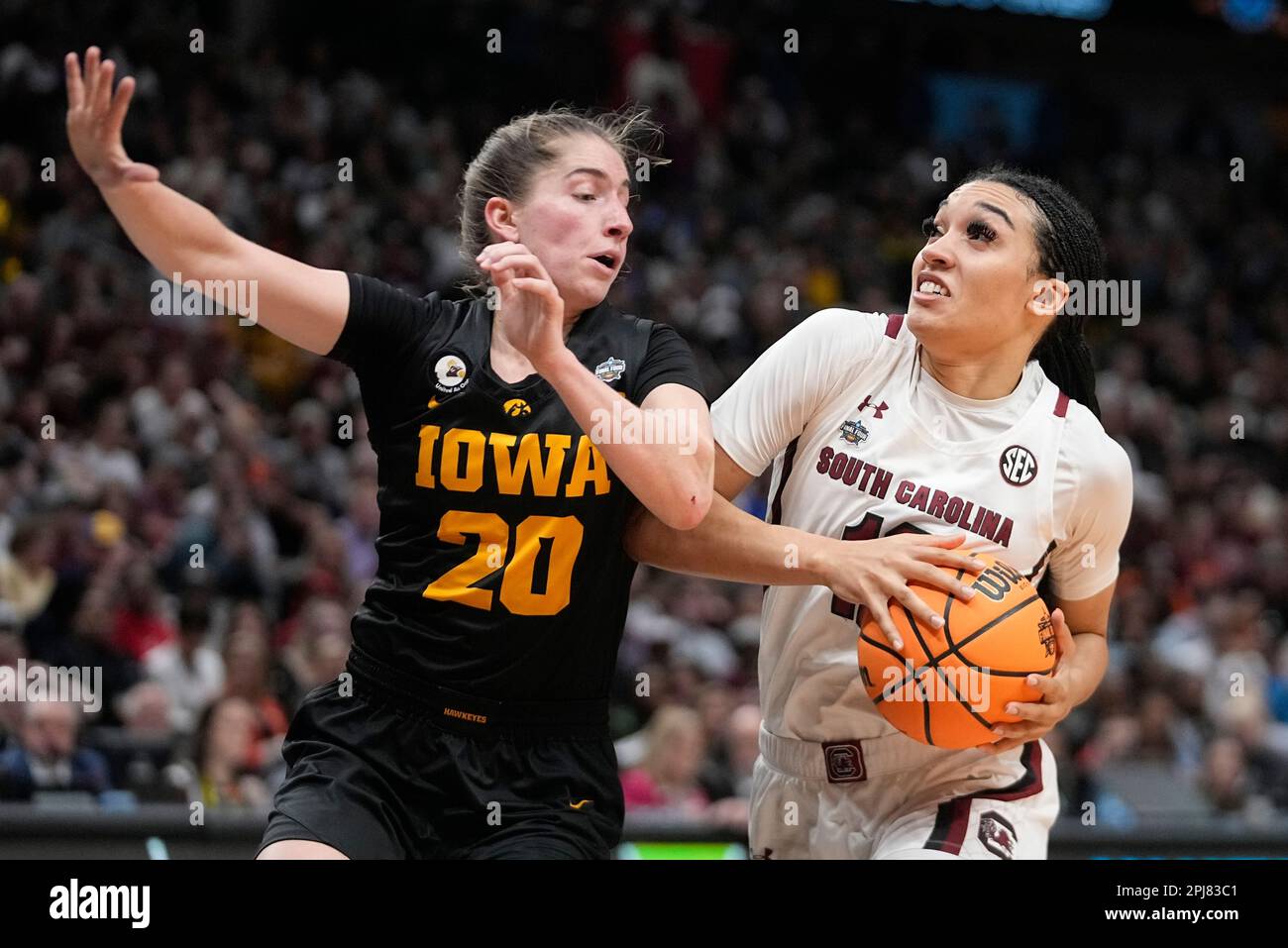 South Carolina's Brea Beal tries to drive by Iowa's Kate Martin during ...