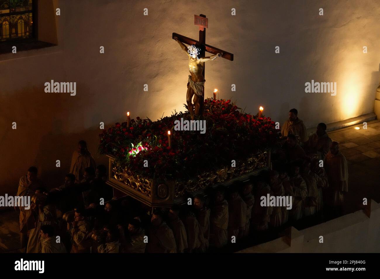 Devotees accompany a religious float transporting a statue depicting ...
