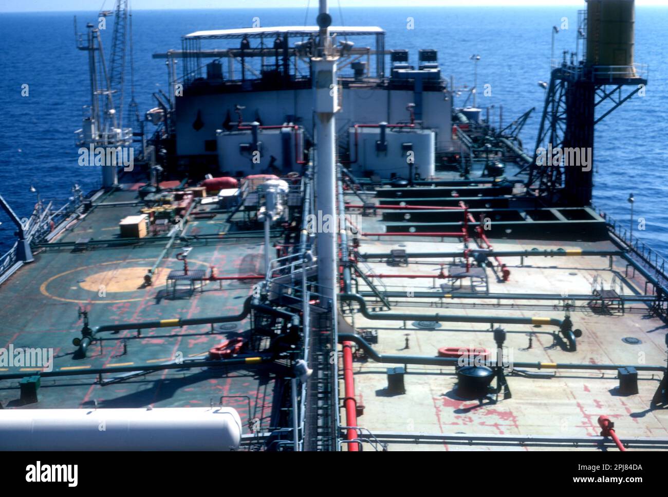 Offshore tanker anchored next to production platform, oil-drilling off ...