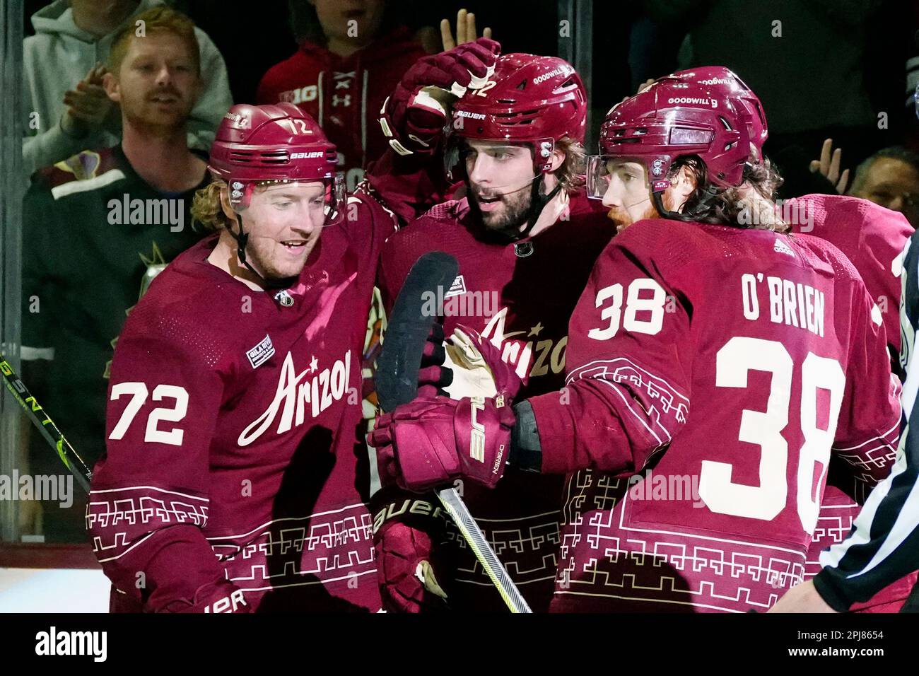 Arizona Coyotes defenseman Connor Mackey, middle, celebrates his goal ...