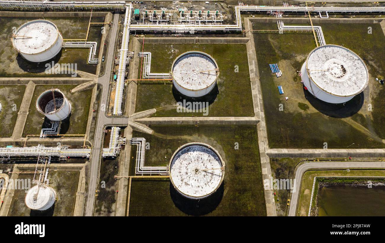 Aerial drone of large above ground tanks store oil and gas in an oil ...