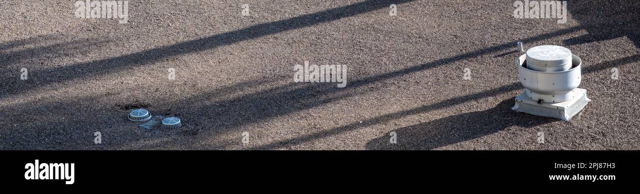 Flat building roof top with ventilation and covered stormwater intake ...
