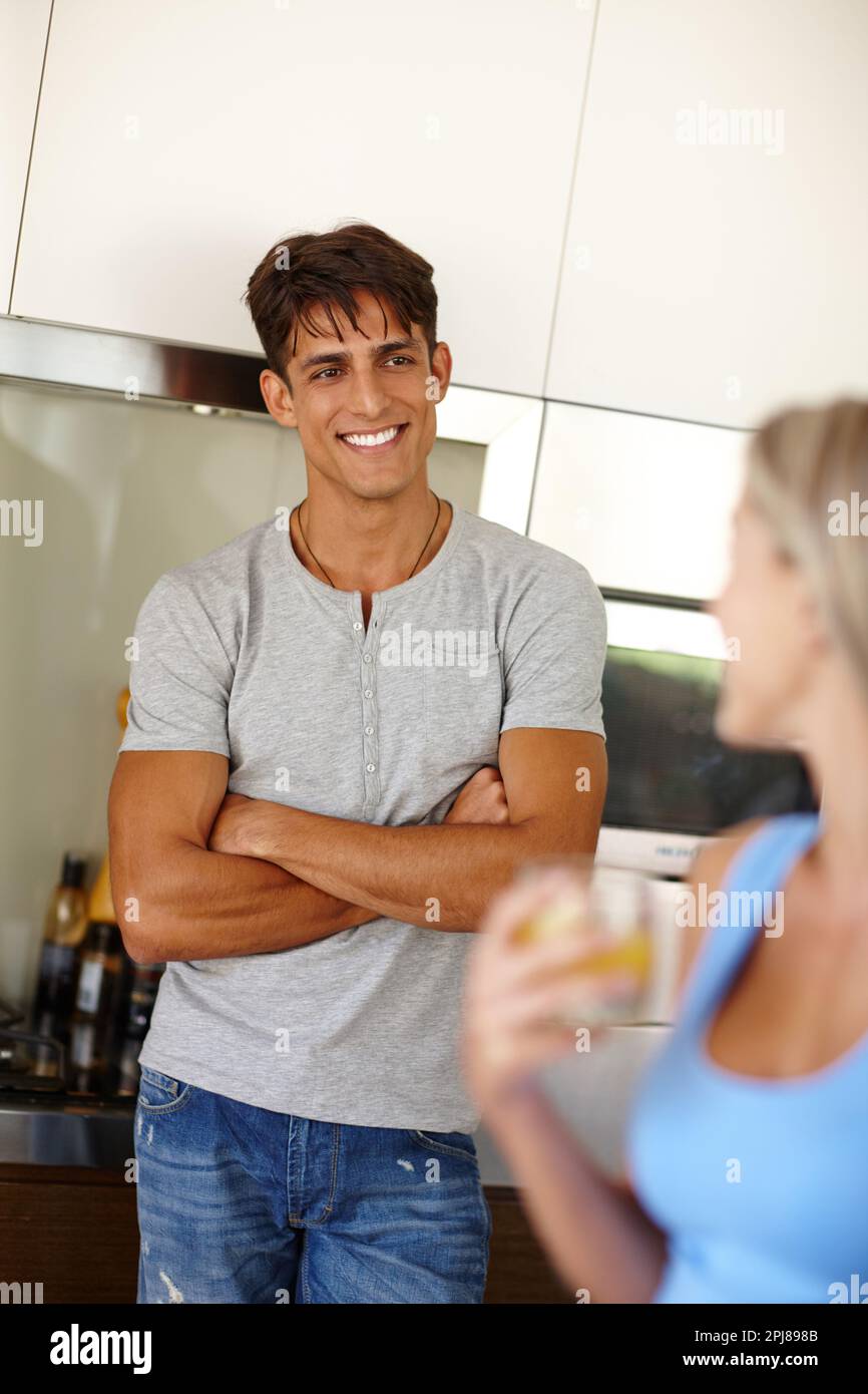 Kitchen conversations. a young couple chatting in the kitchen Stock ...