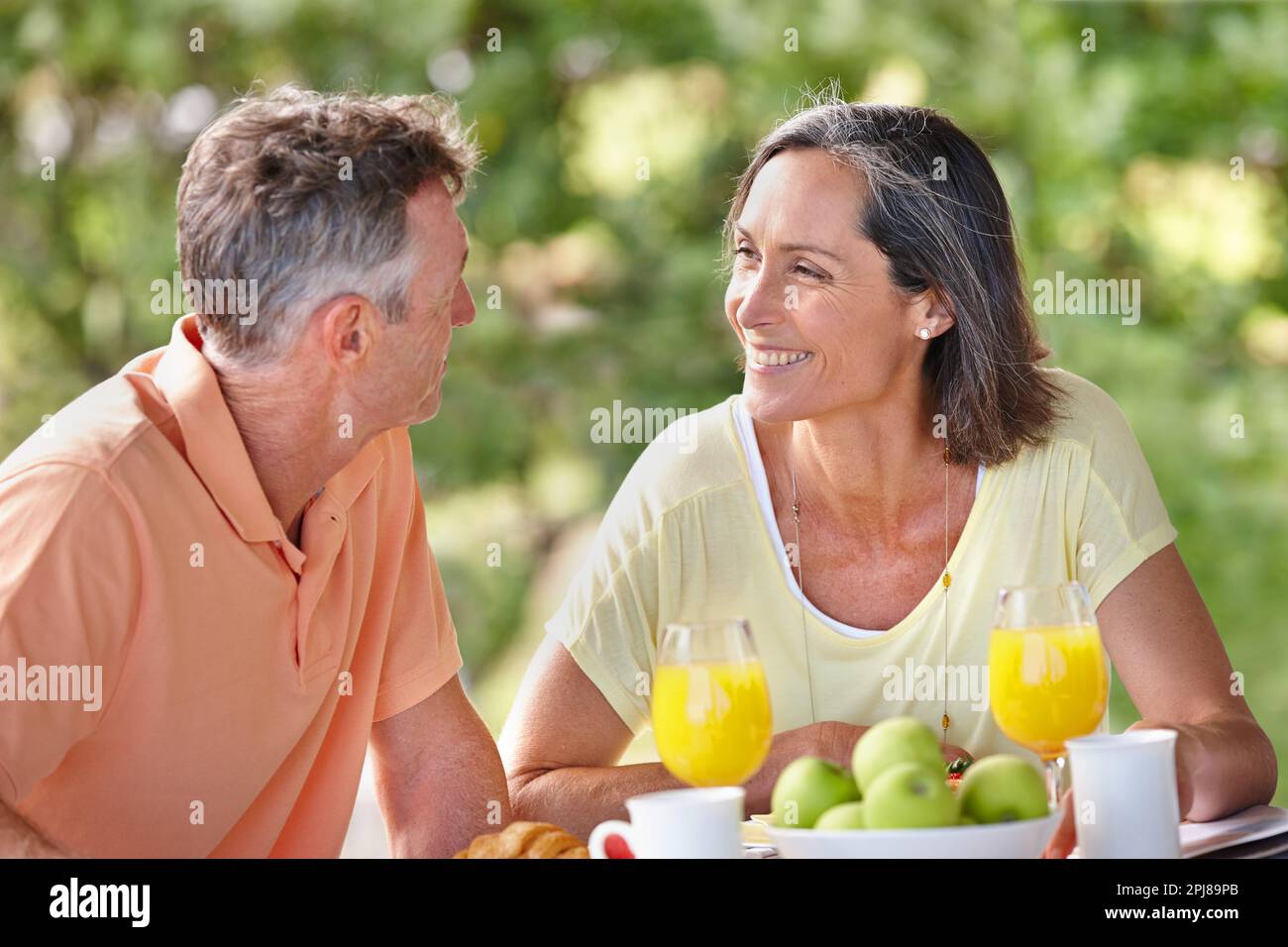 Love in daily life. a loving mature couple having breakfast together ...
