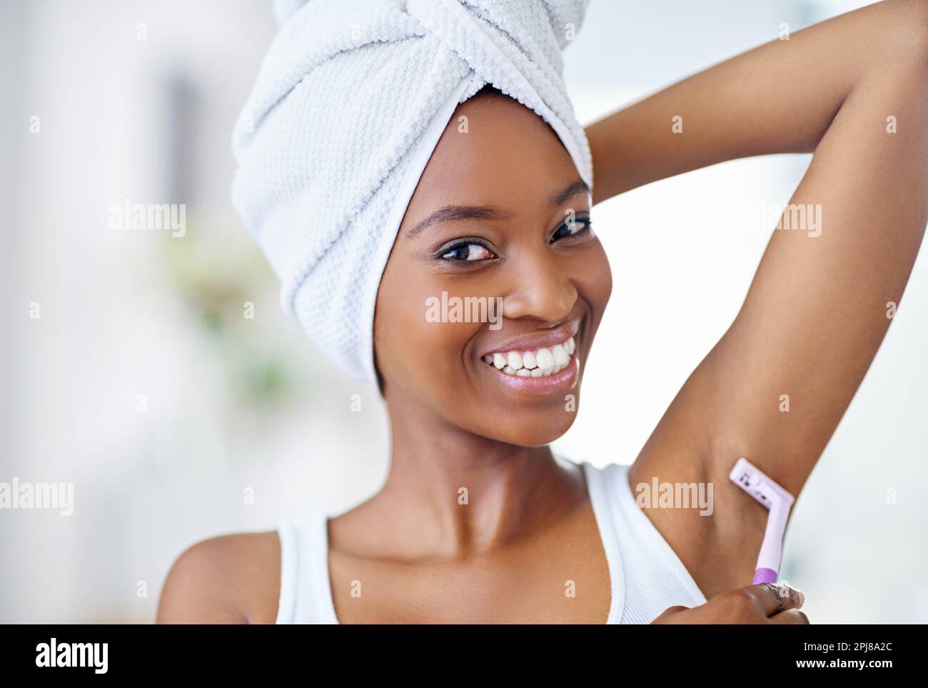 Set your razor to stun. a beautiful young woman during her daily beauty ...