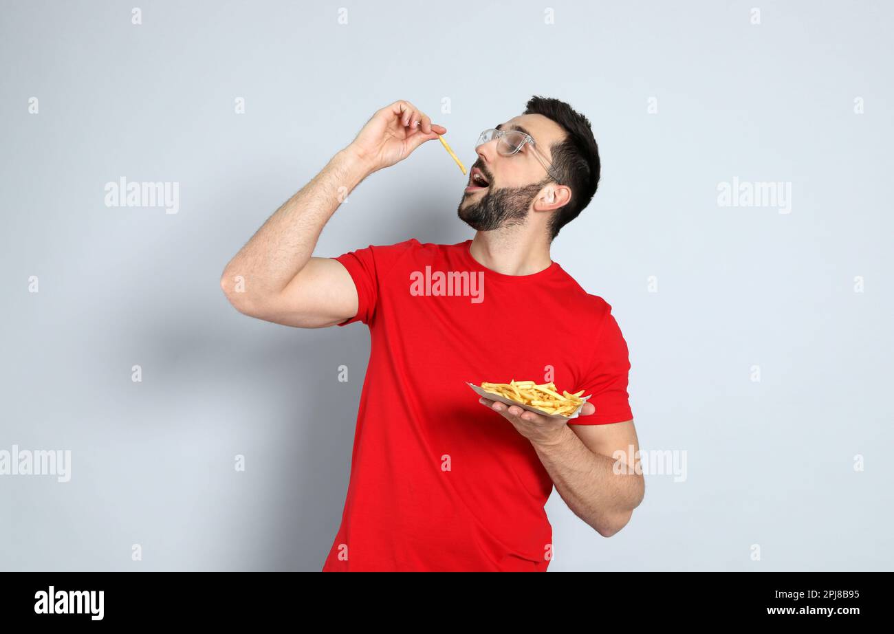 Man eating french fries hi-res stock photography and images - Alamy