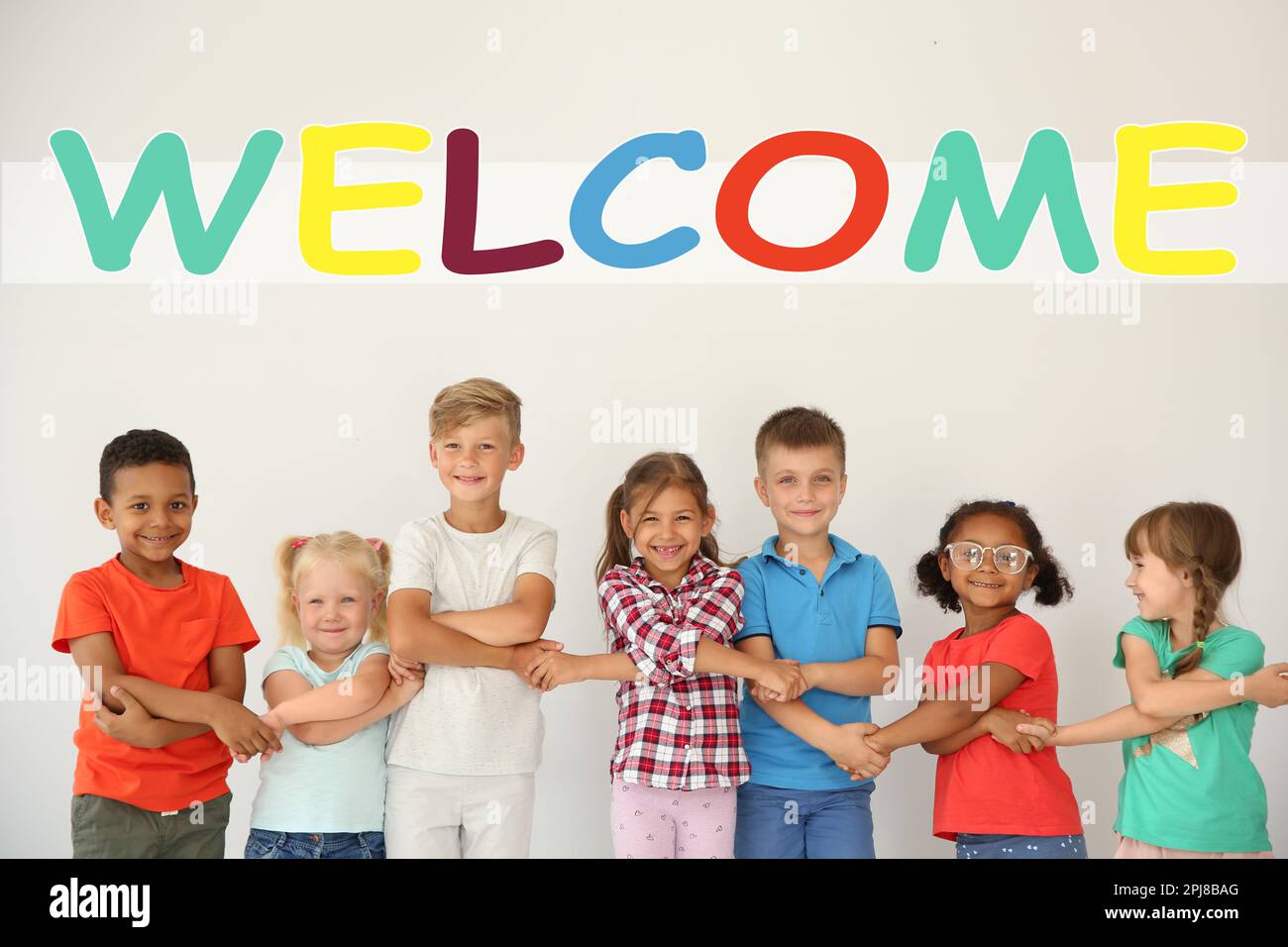 Word Welcome over little children holding hands on light background ...