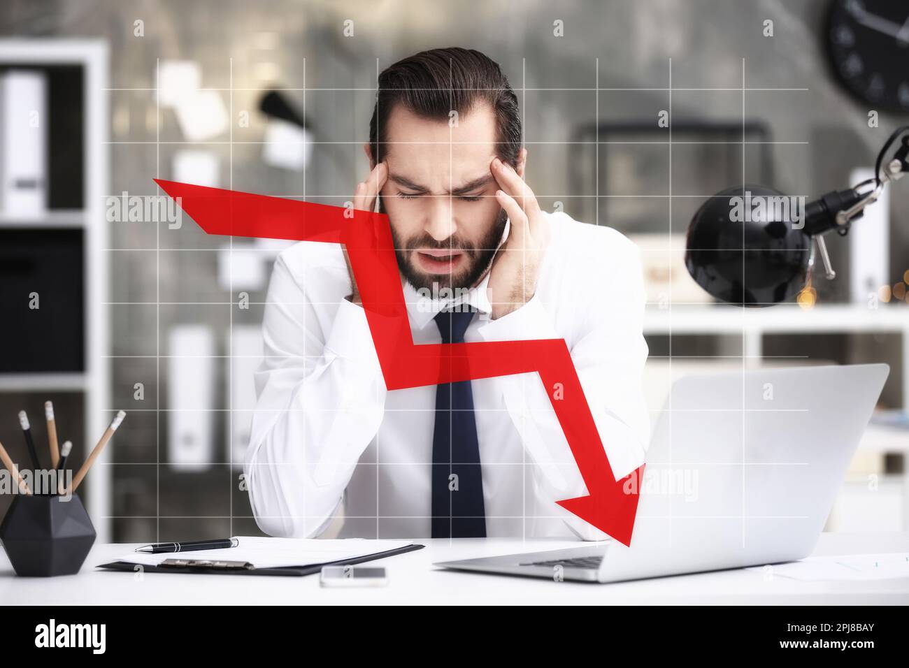 Stressed businessman at table in office and illustration of falling ...
