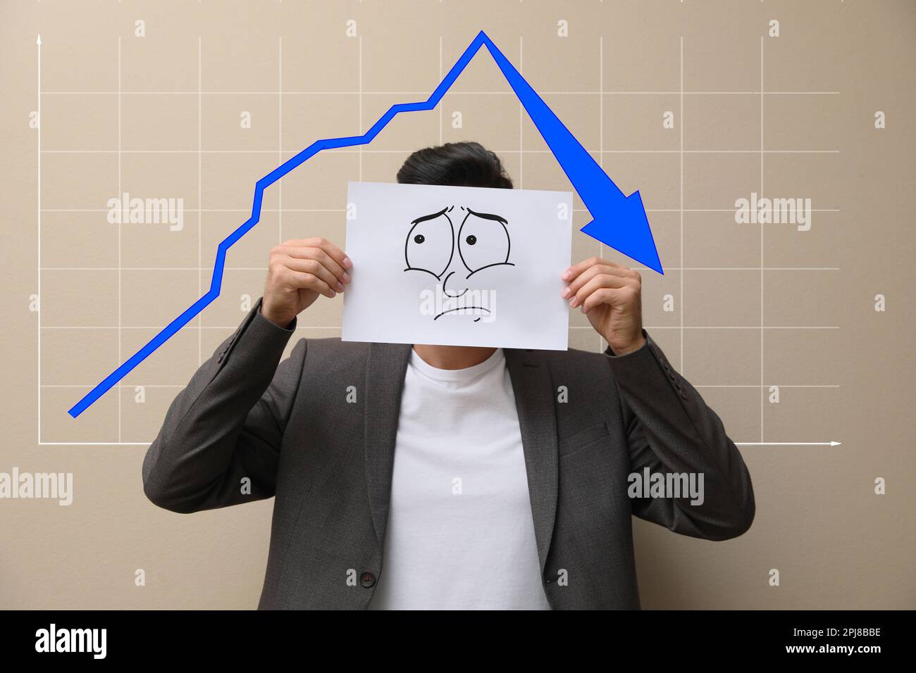 Businessman holding card with drawn frowning face and illustration of ...