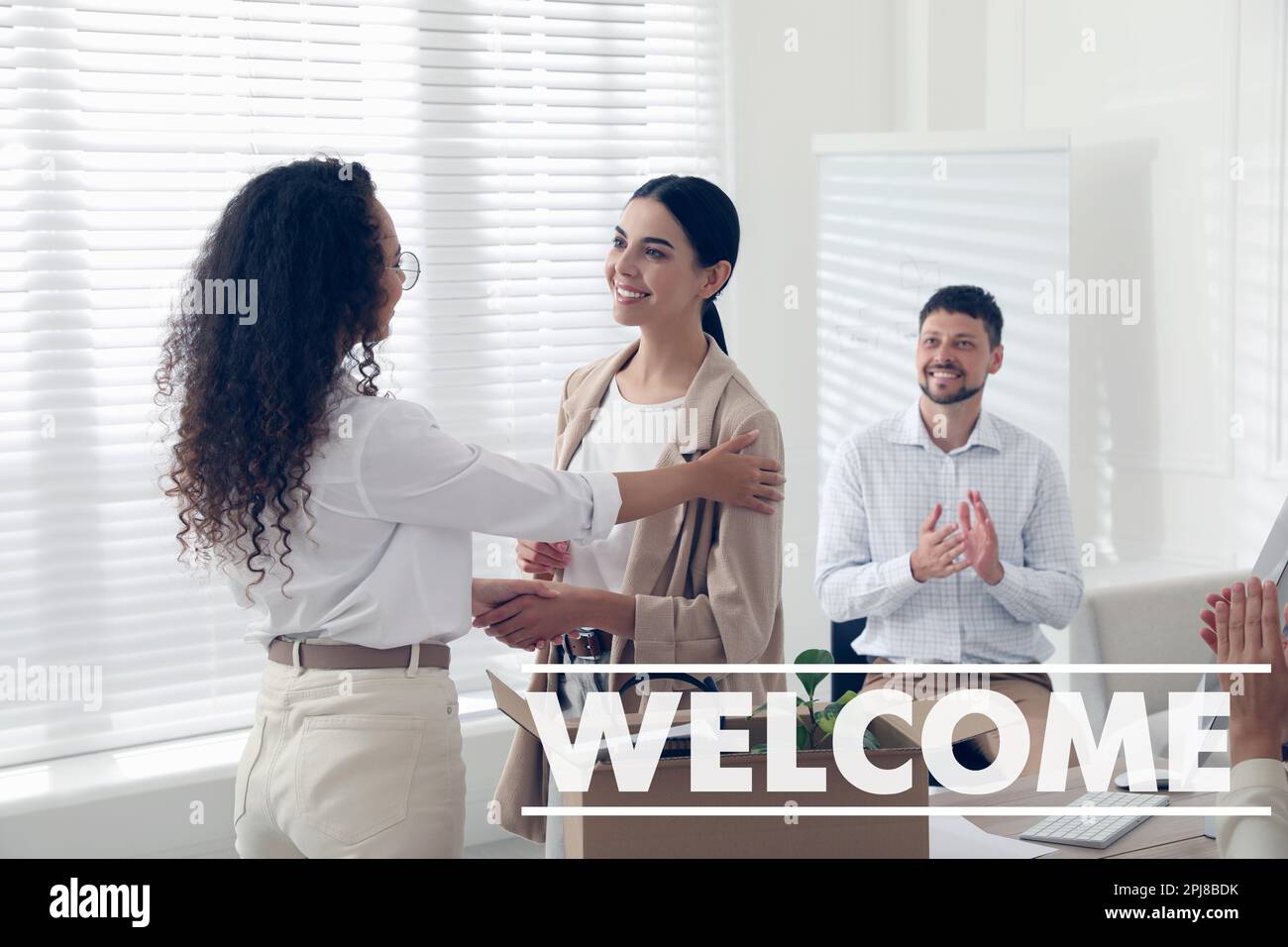 Welcome to team. Employee shaking hands with intern in office Stock ...