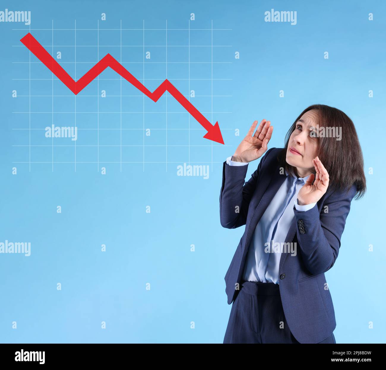 Worried businesswoman and illustration of falling down chart on light ...