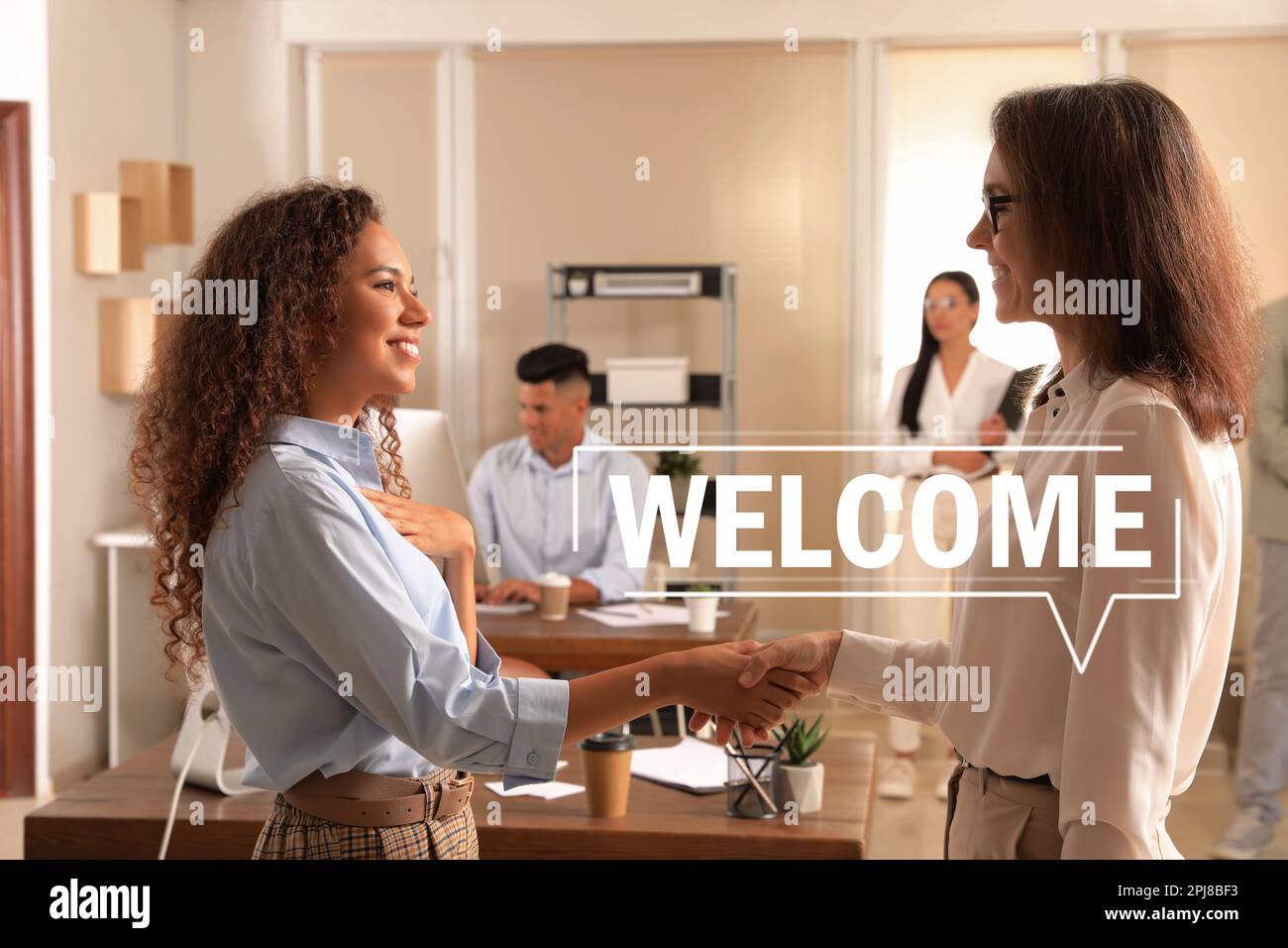 Welcome to team. Employee shaking hands with intern in office Stock ...