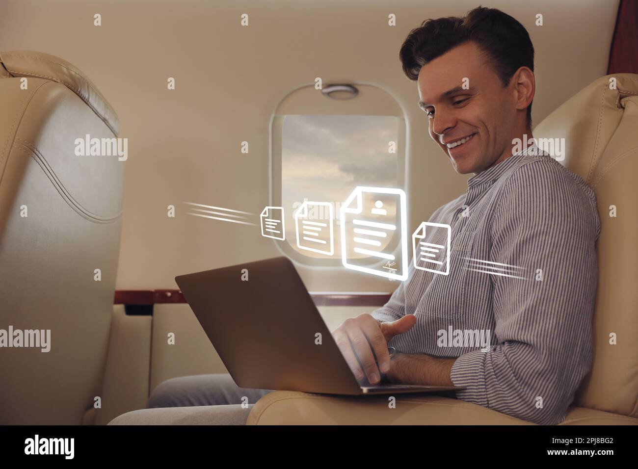 Concept of electronic signature. Man using laptop in airplane during ...