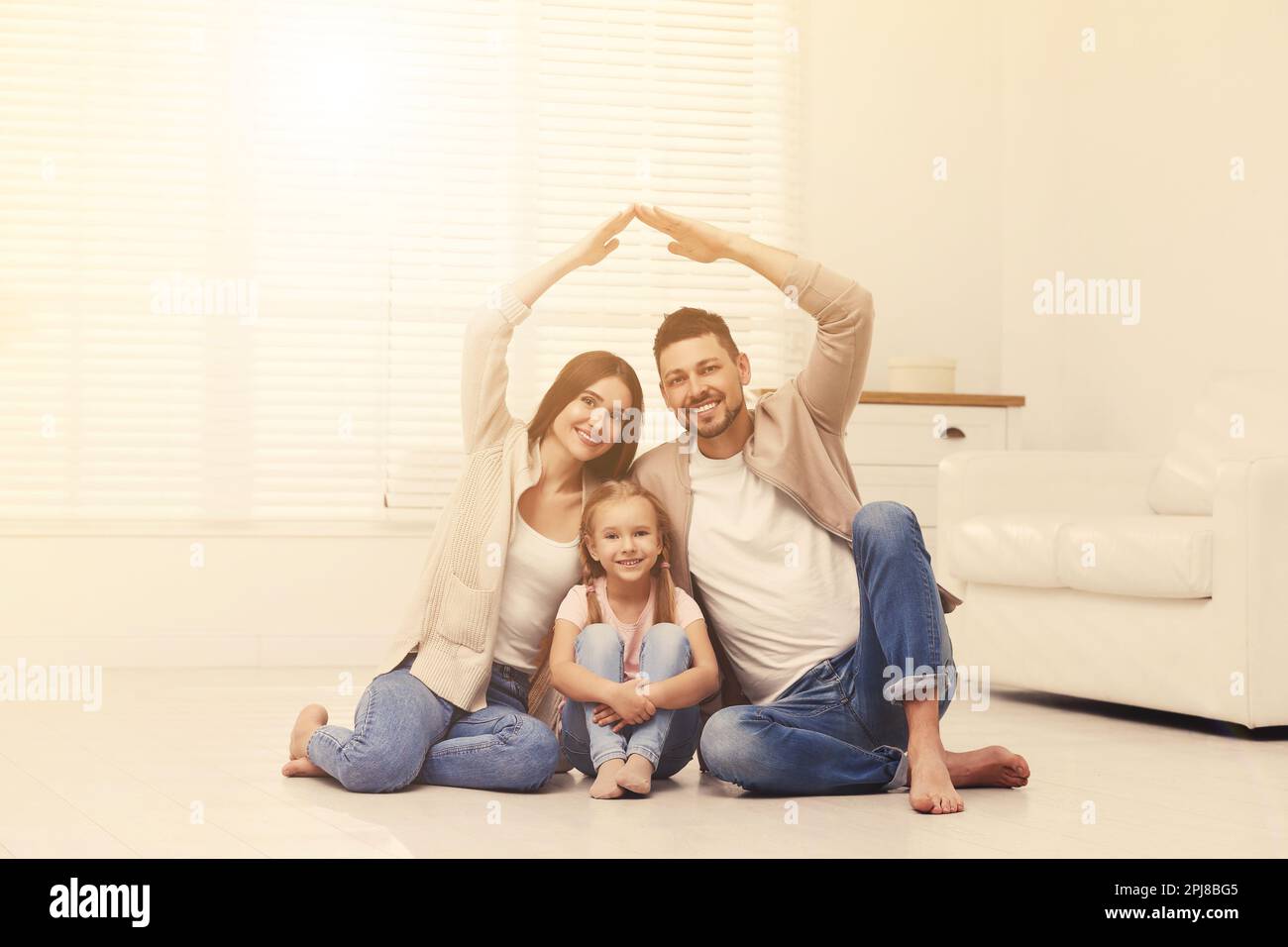 Happy family forming house roof with their hands at home. Insurance ...