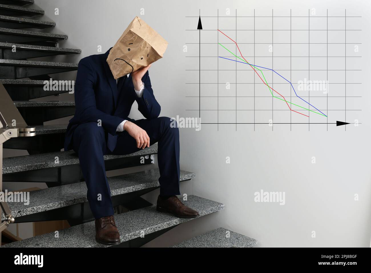 Man wearing paper bag with drawn sad face indoors and illustration of ...