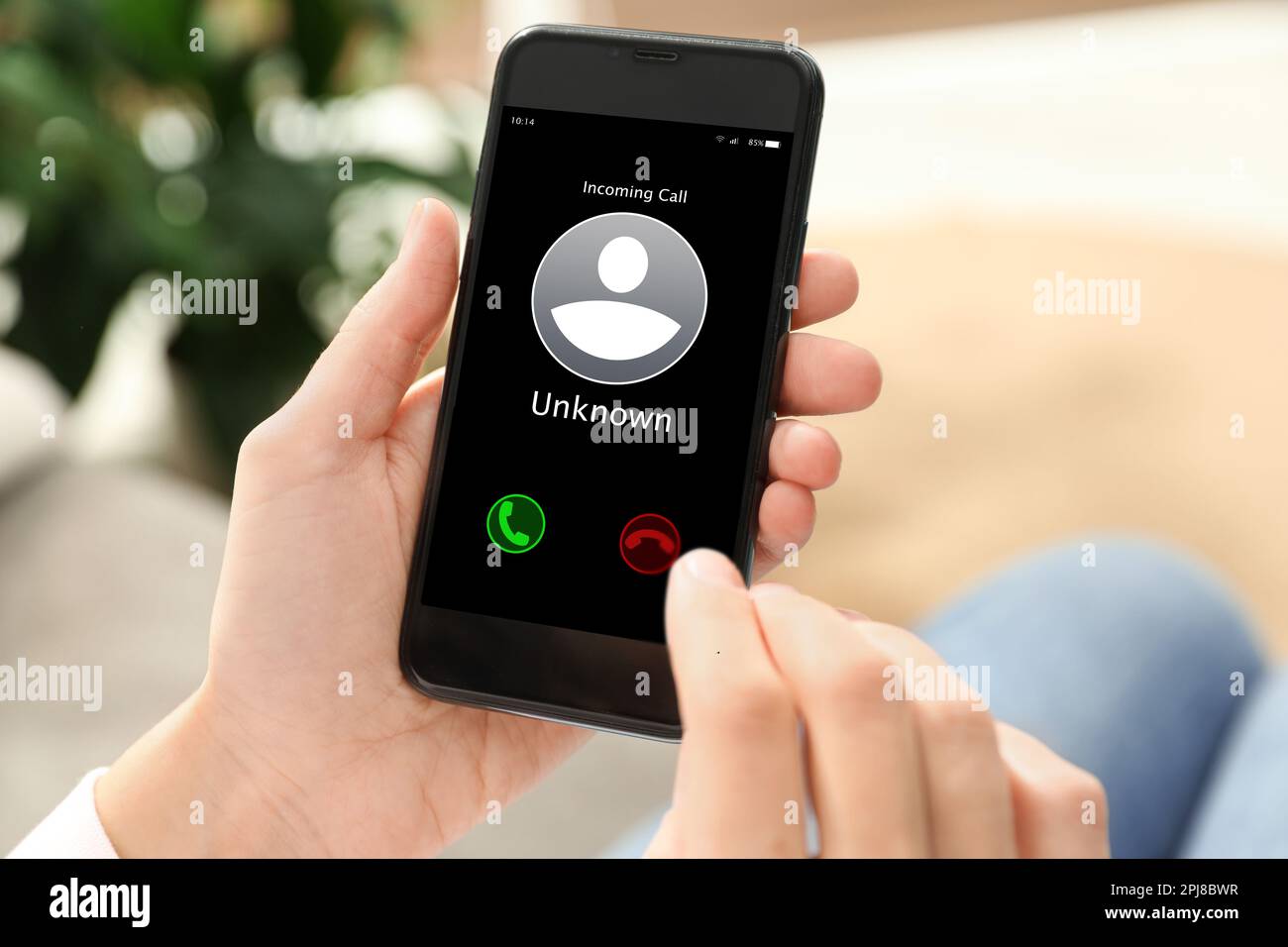 Woman declining incoming call from unknown caller indoors, closeup. Be ...