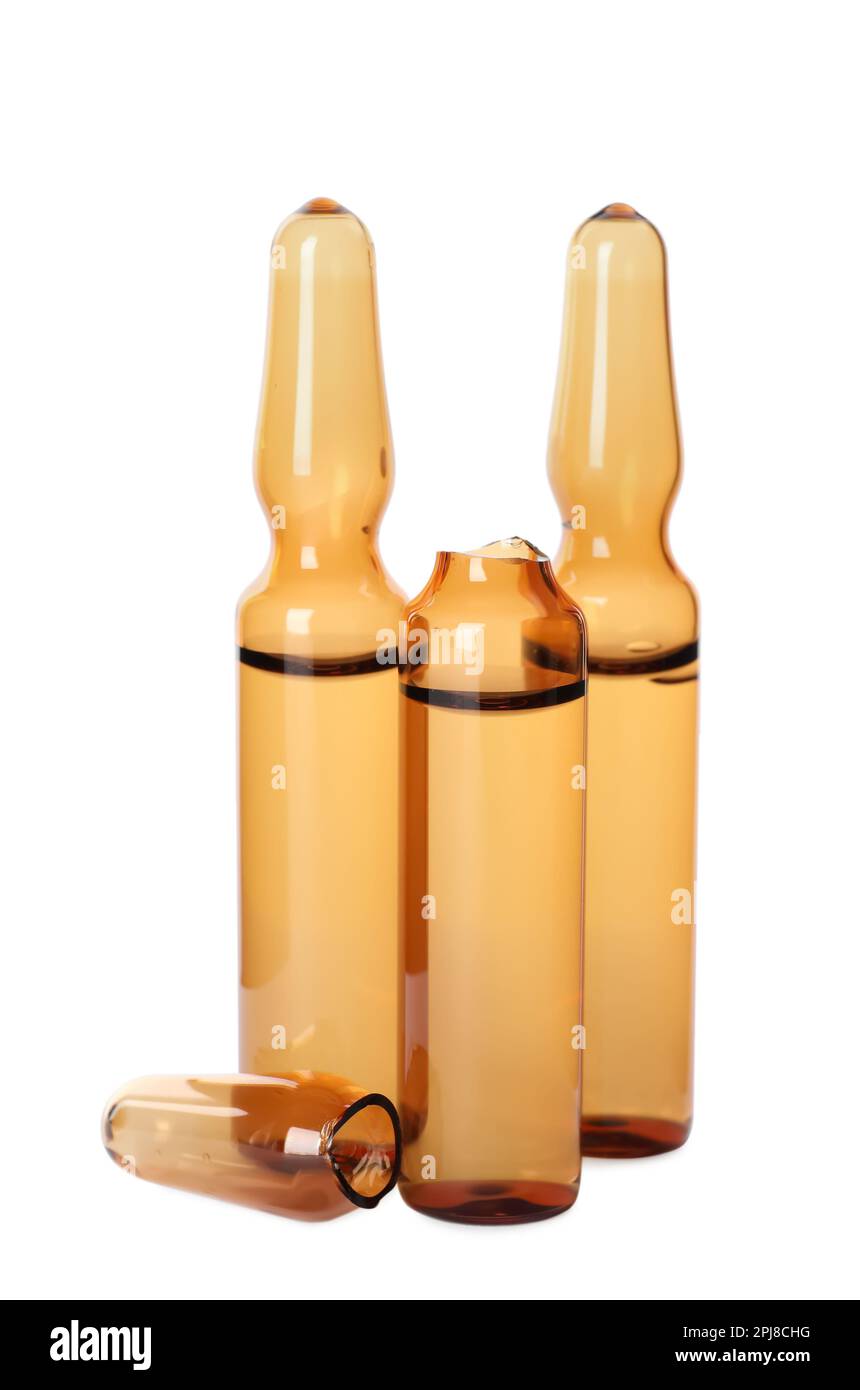 Open and closed glass ampoules with pharmaceutical product on white ...