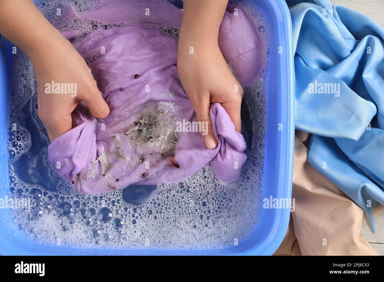 Woman washing garment with stain, top view Stock Photo - Alamy