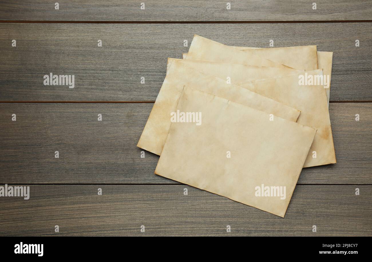 Pile of old letters on wooden table, top view. Space for text Stock ...
