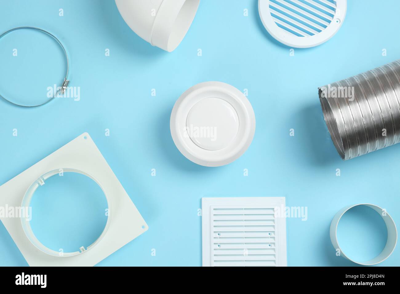 Parts of home ventilation system on light blue background, flat lay ...