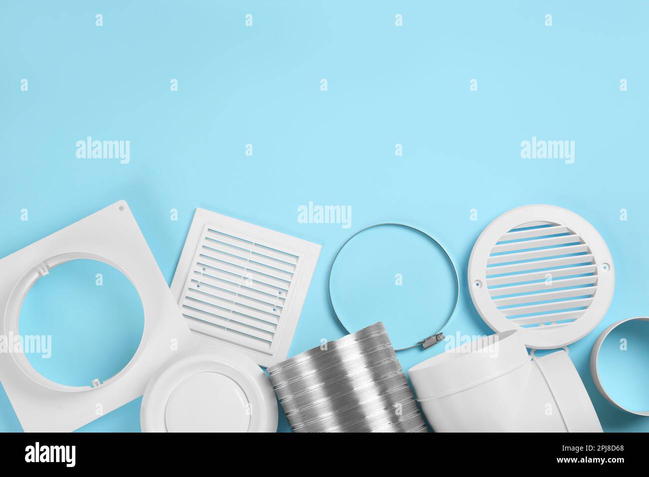 Parts of home ventilation system on light blue background, flat lay ...