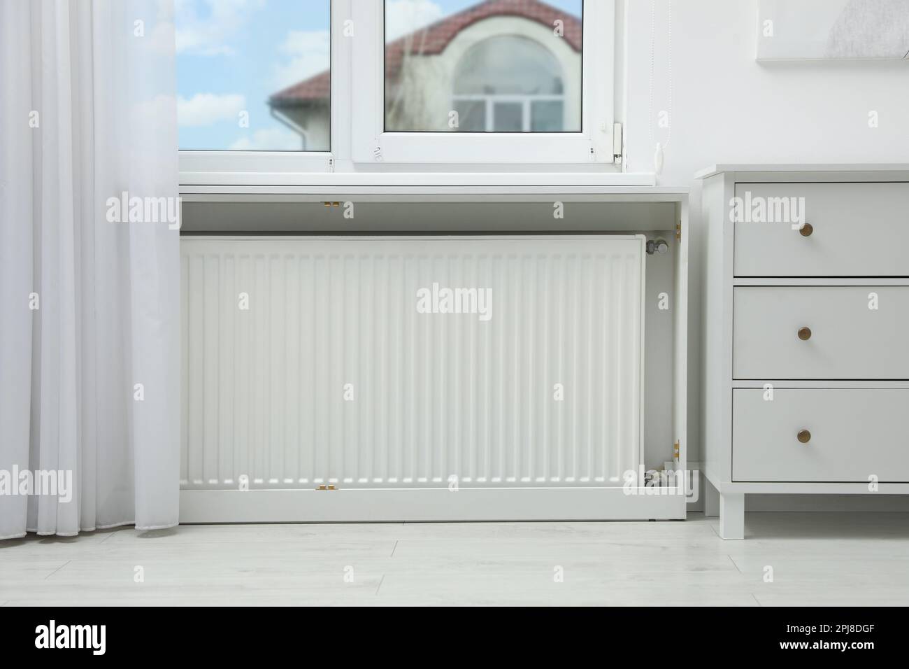 Modern radiator at home. Central heating system Stock Photo - Alamy