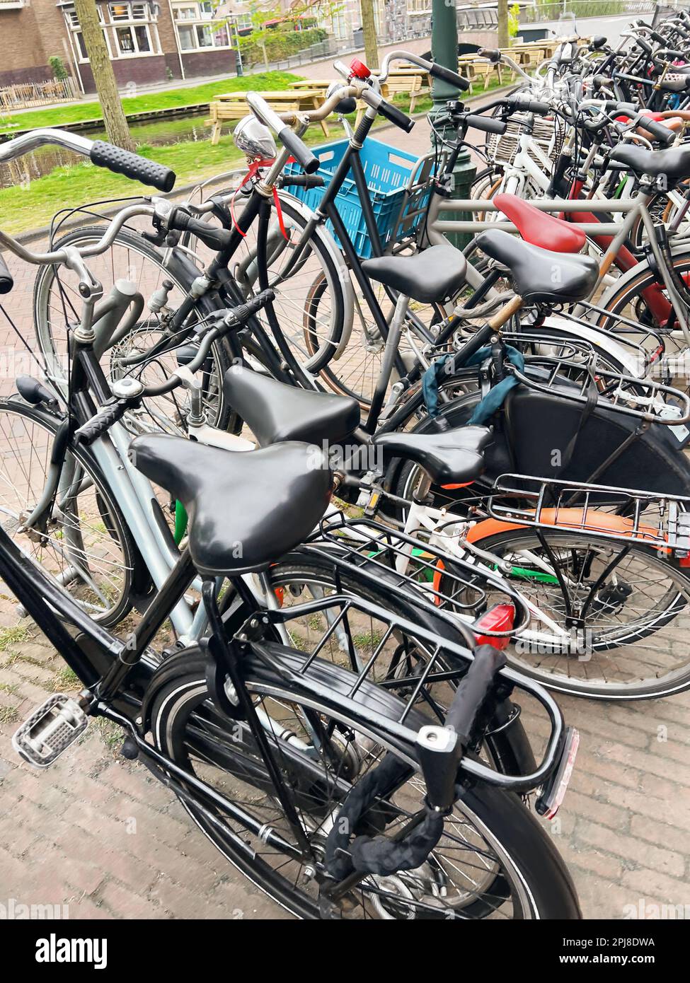 Many different bicycles parked on sidewalk, closeup Stock Photo - Alamy
