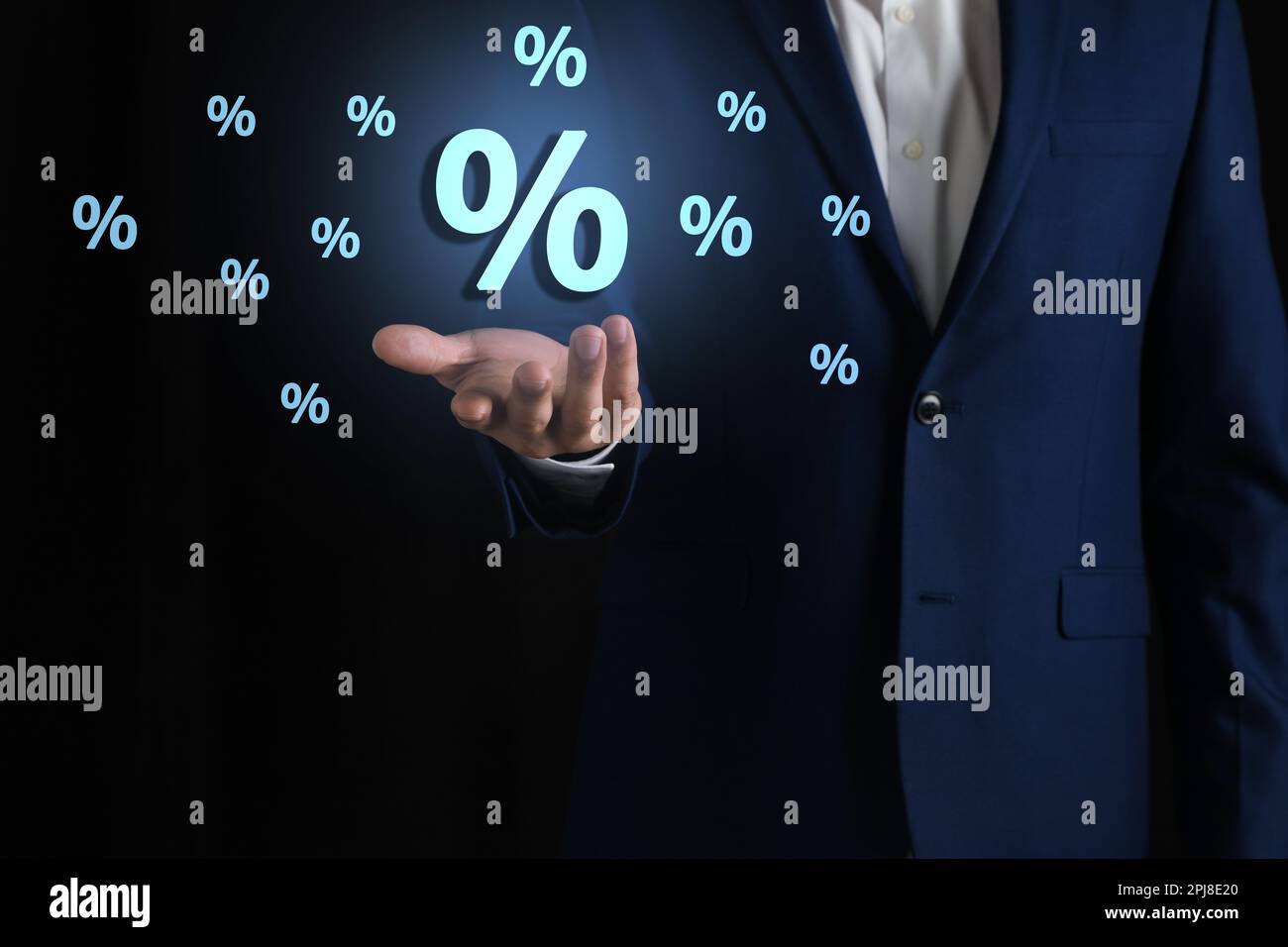 Man showing virtual percent sign on black background, closeup. Discount ...