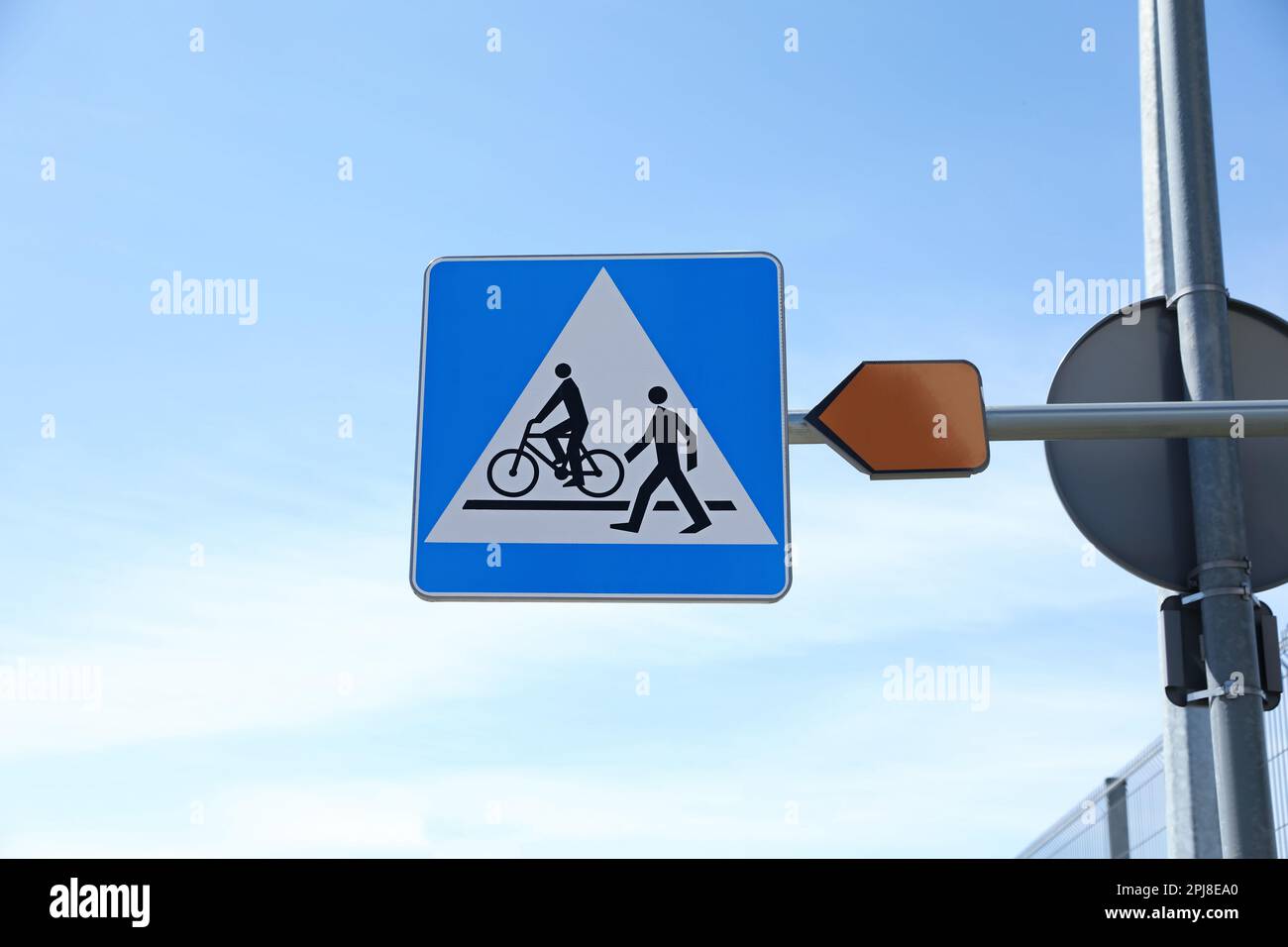 Road sign pedestrian and bicycle crossing against blue sky Stock Photo ...