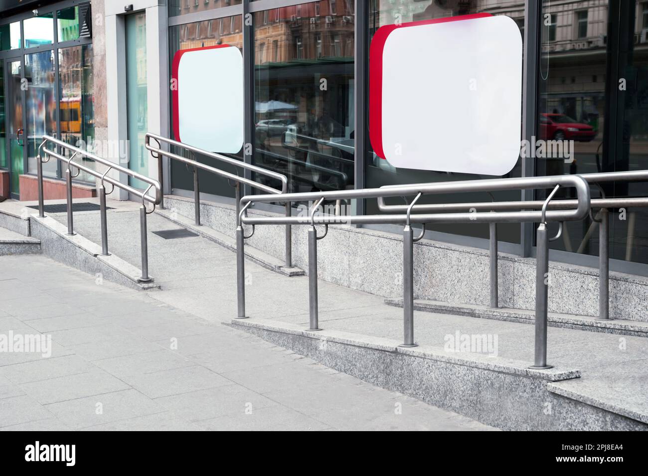 Tiled ramps with shiny metal railings outdoors Stock Photo - Alamy