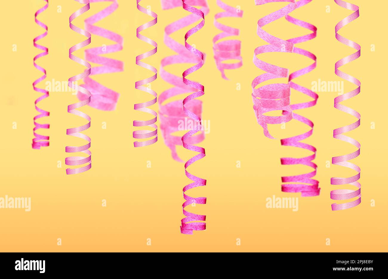 Shiny serpentine streamers on pink hi-res stock photography and images ...