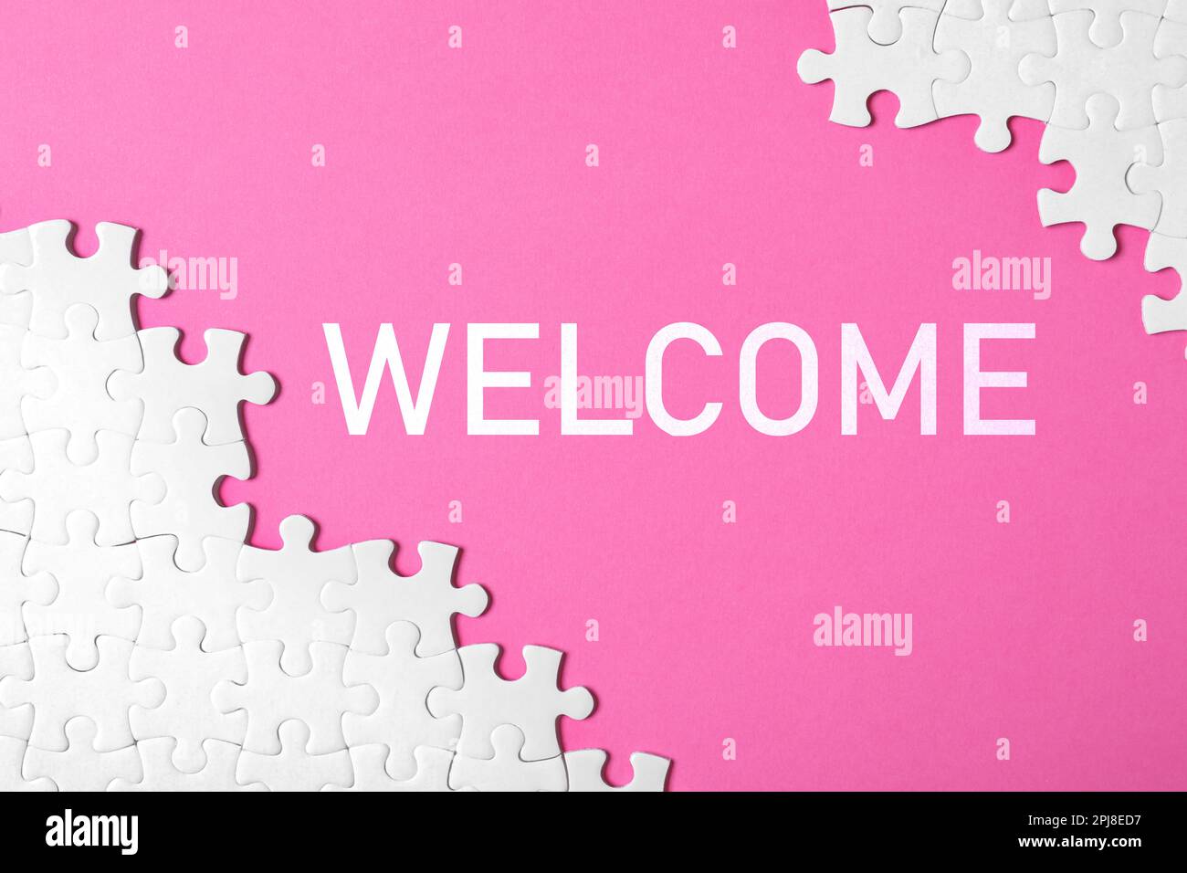 White puzzle pieces and word WELCOME on pink background, flat lay Stock ...