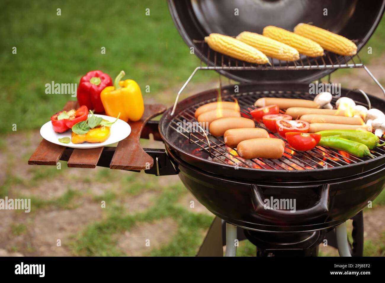 Barbecue grill with tasty fresh food outdoors Stock Photo - Alamy