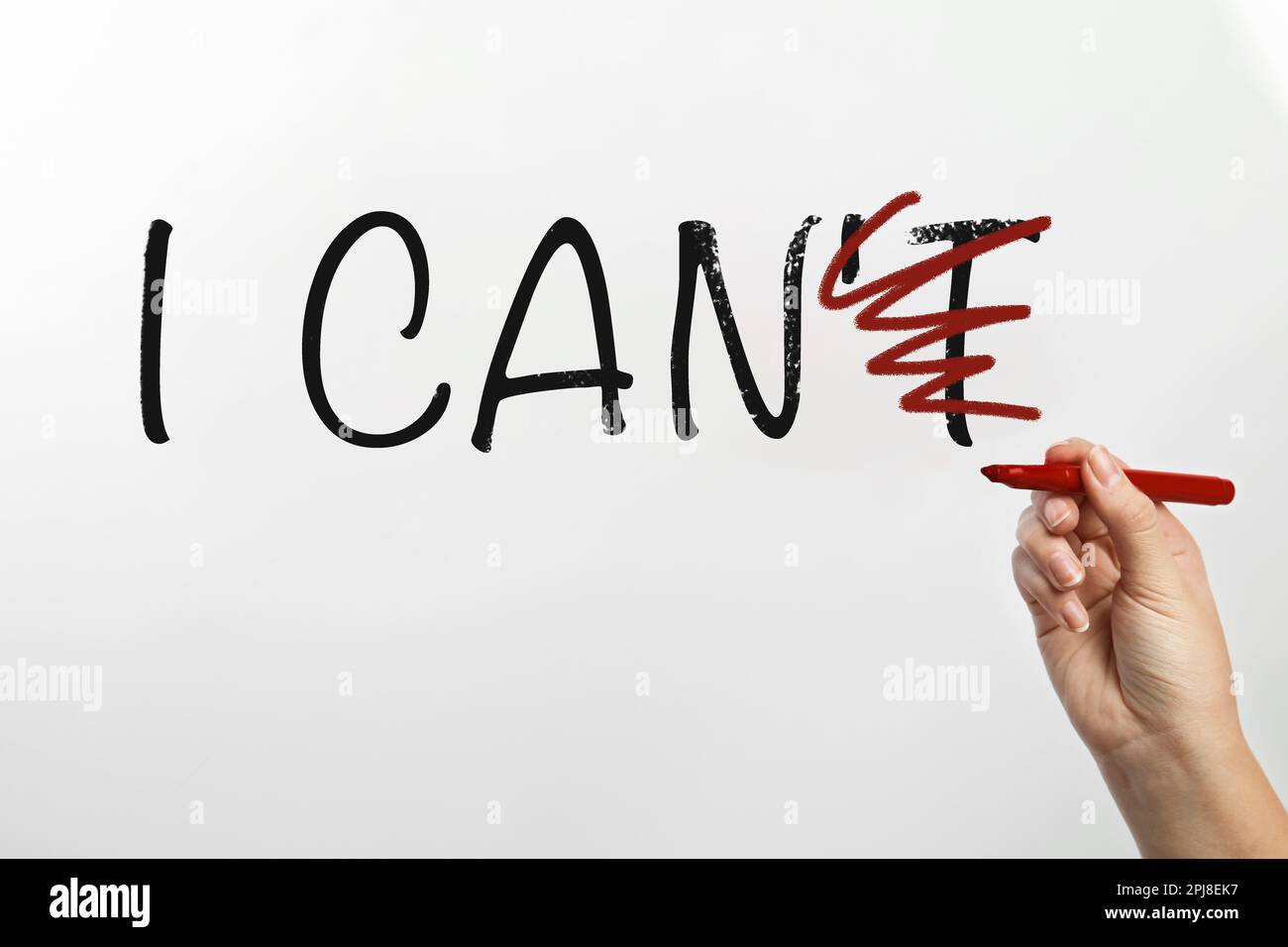 Woman crossed out letter T in phrase I CAN'T on white background ...