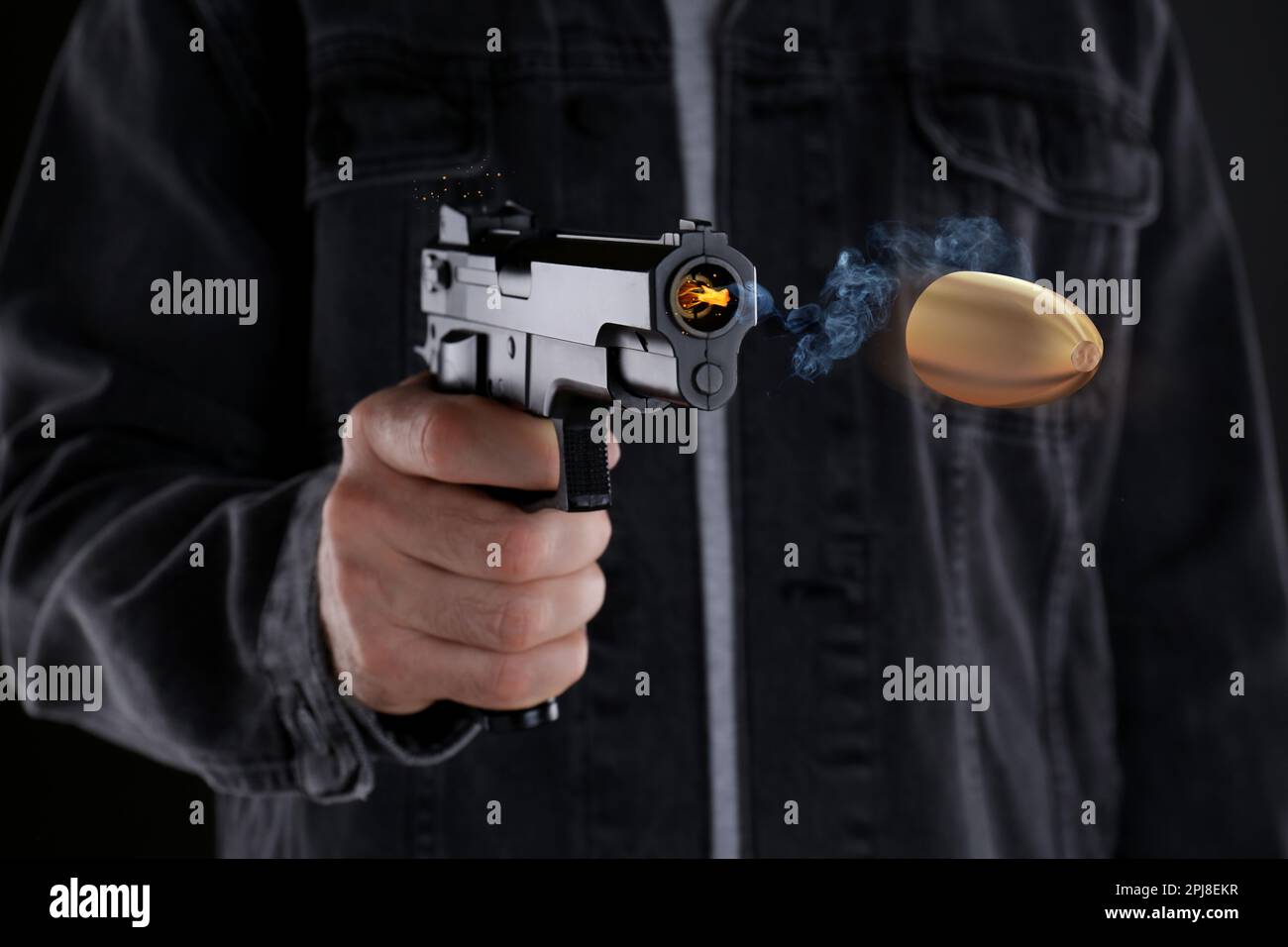 Man shooting from gun on black background, closeup Stock Photo - Alamy