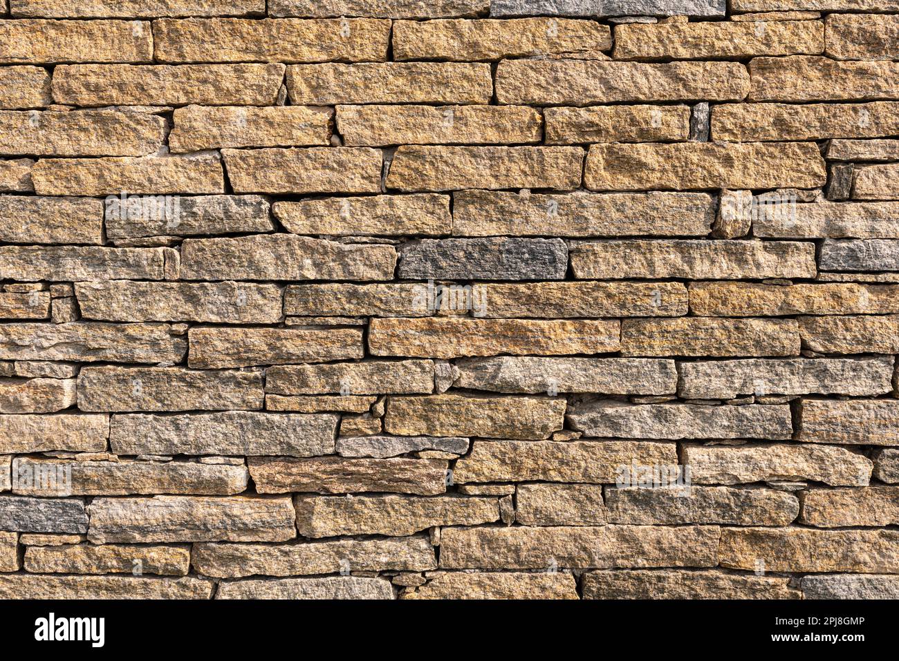Yellow stone brick wall pattern suitable as wallpaper Stock Photo - Alamy