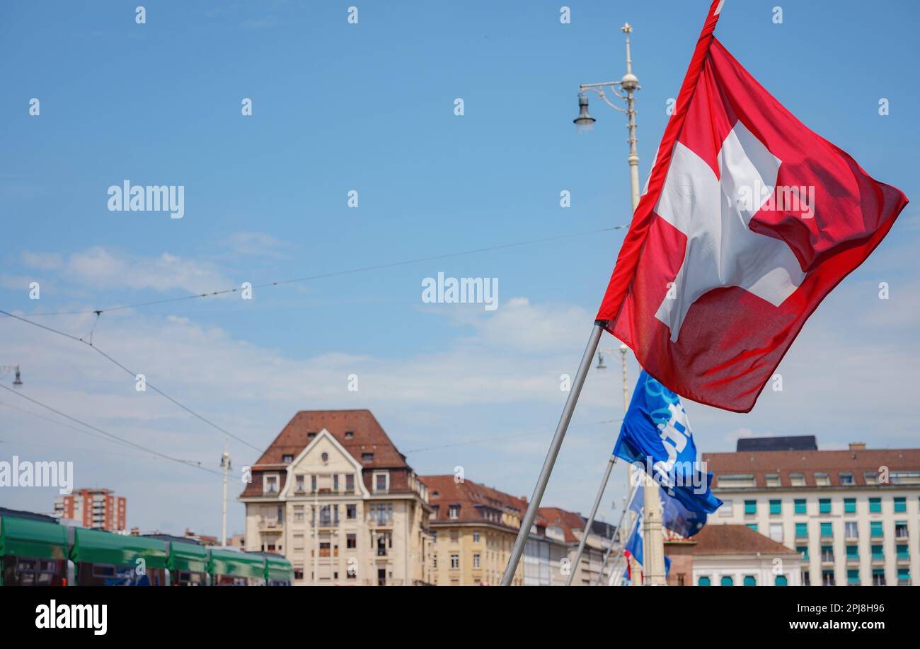 Beautiful Swiss flag is waving front of historical street in Basel ...