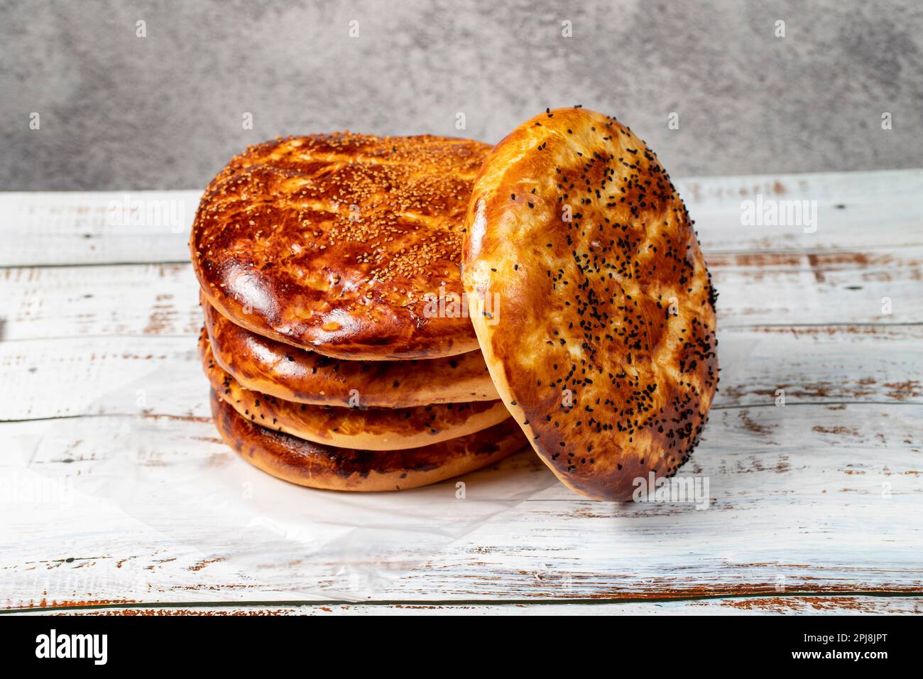 Sesame ramadan pita on a wood floor. Ramadan delicacies. Pita bread ...