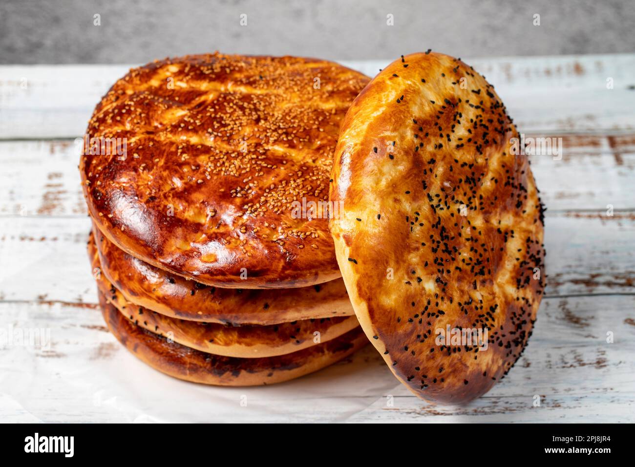 Sesame ramadan pita on a wood floor. Ramadan delicacies. Pita bread ...
