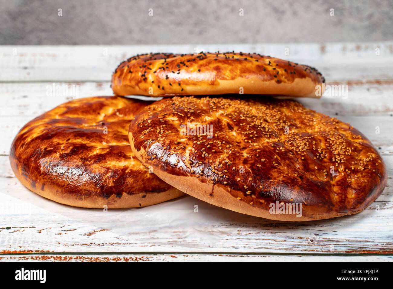 Sesame ramadan pita on a wood floor. Ramadan delicacies. Pita bread ...