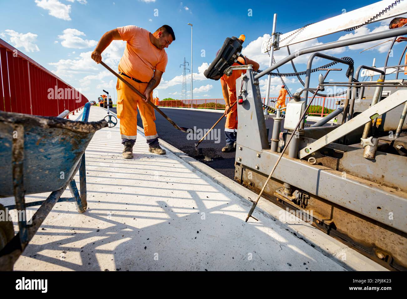 View on machine for laying asphalt, spreading layer of hot tarmac on ...