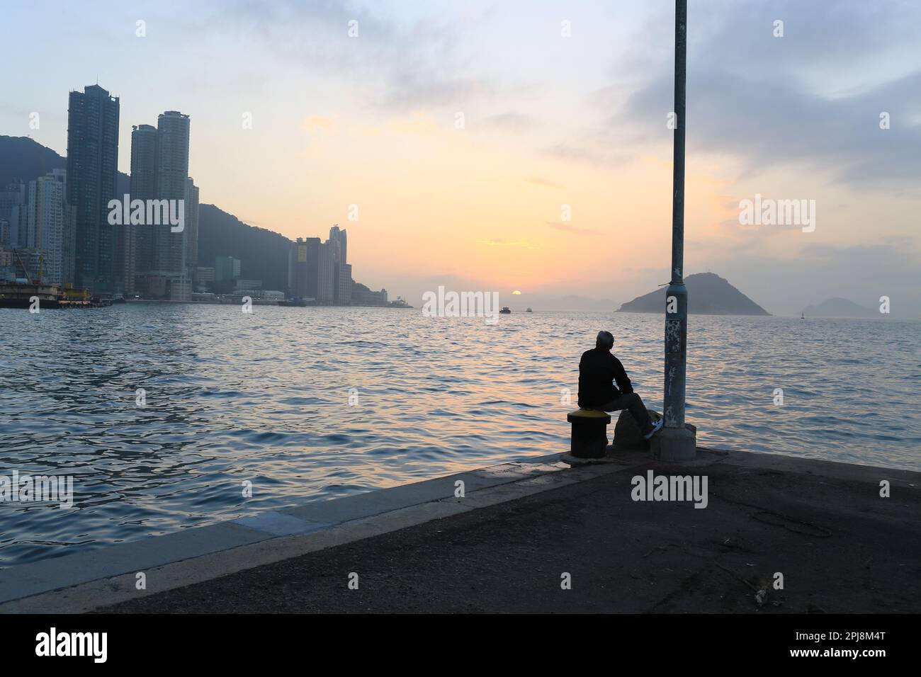 Man watching the far away sunset deep thinking in the pier waiting ...