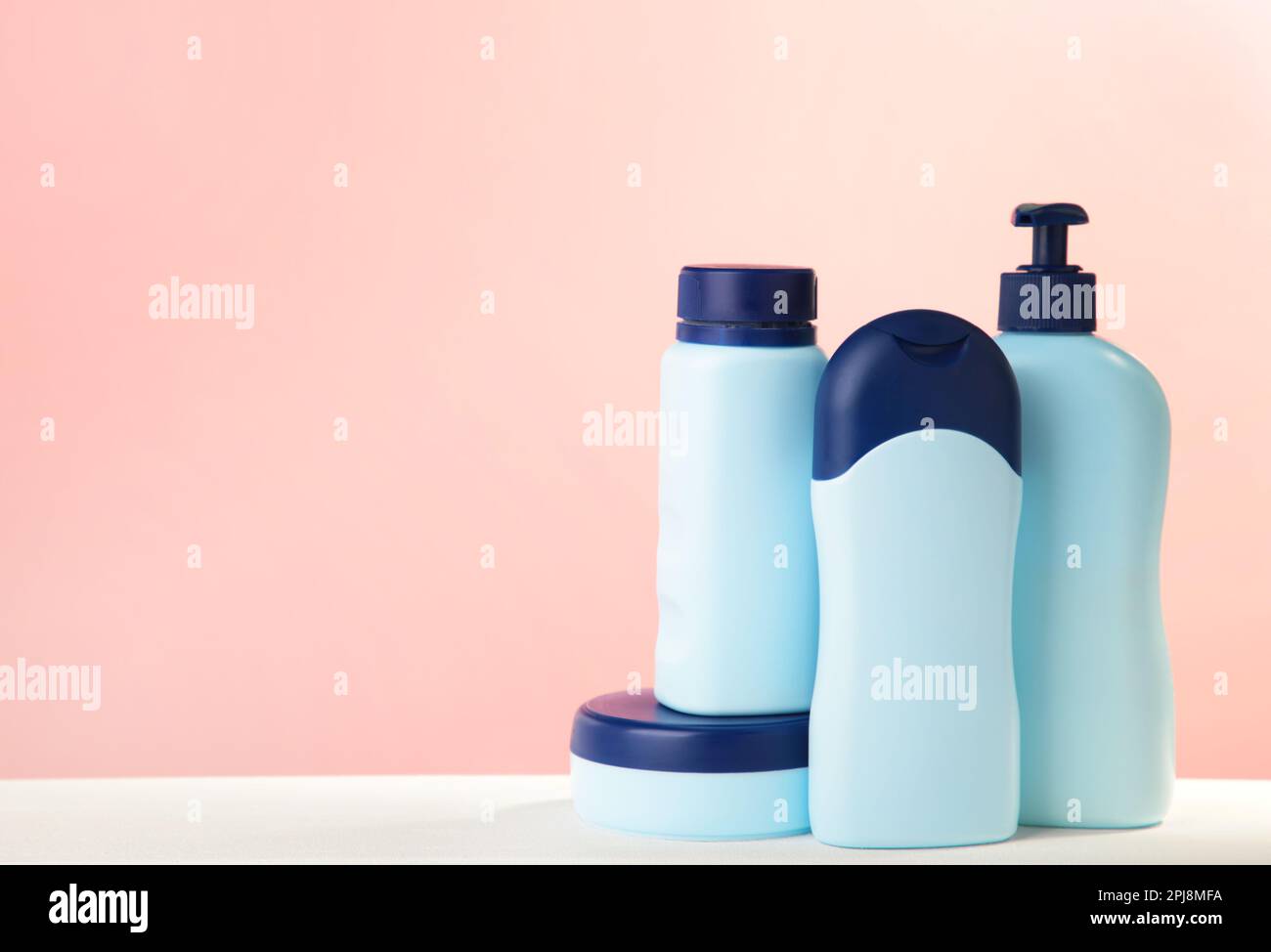 Blue cosmetic bottles on pink background. Set of bottles Stock Photo ...