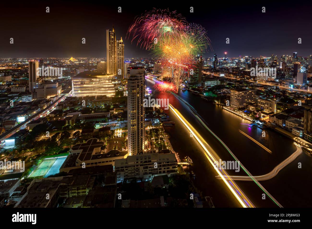 Modern buildings in the city with water reflection, firework, light ...