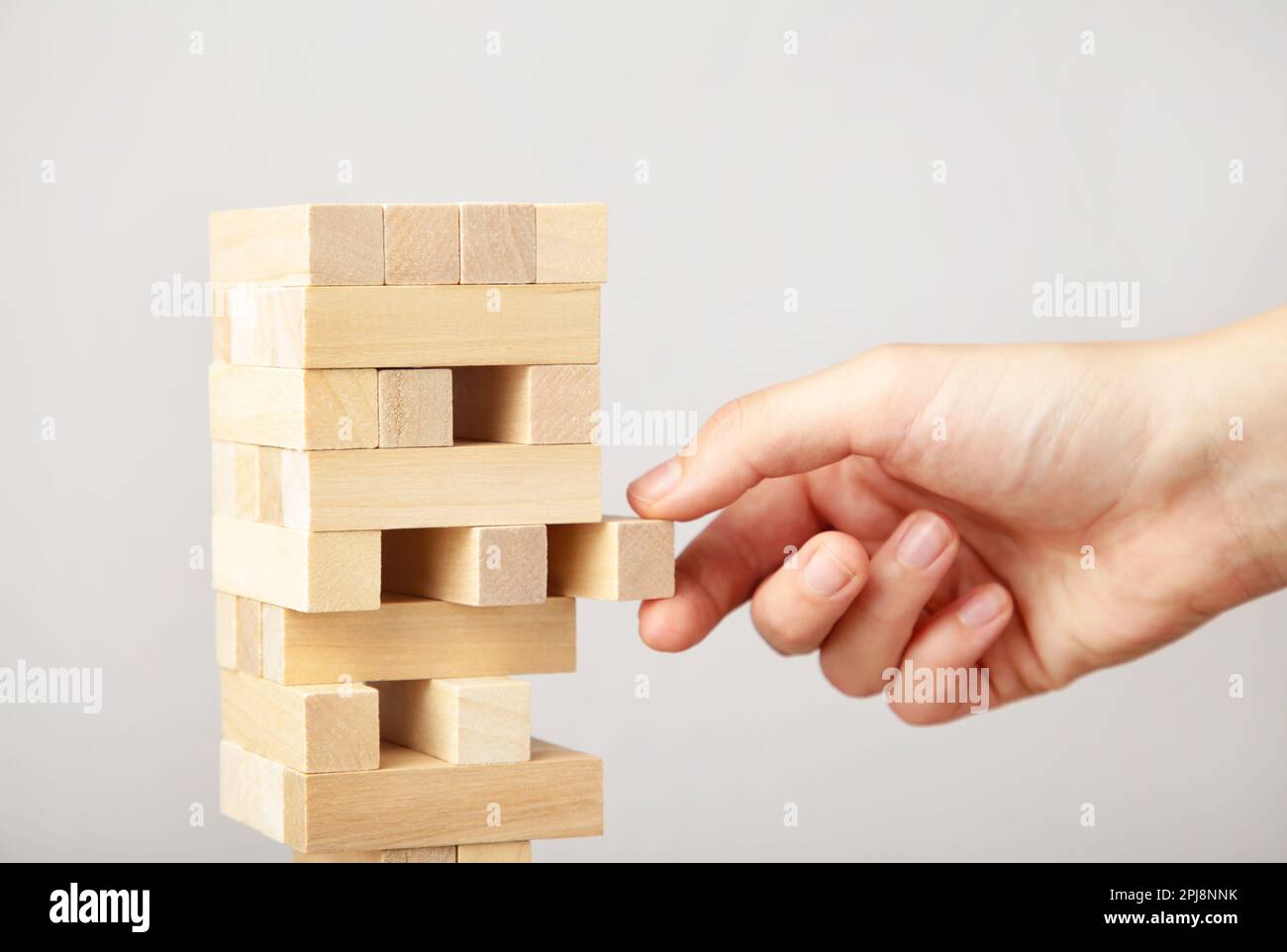 Business woman hand pick and put last piece block of the wood puzzle ...