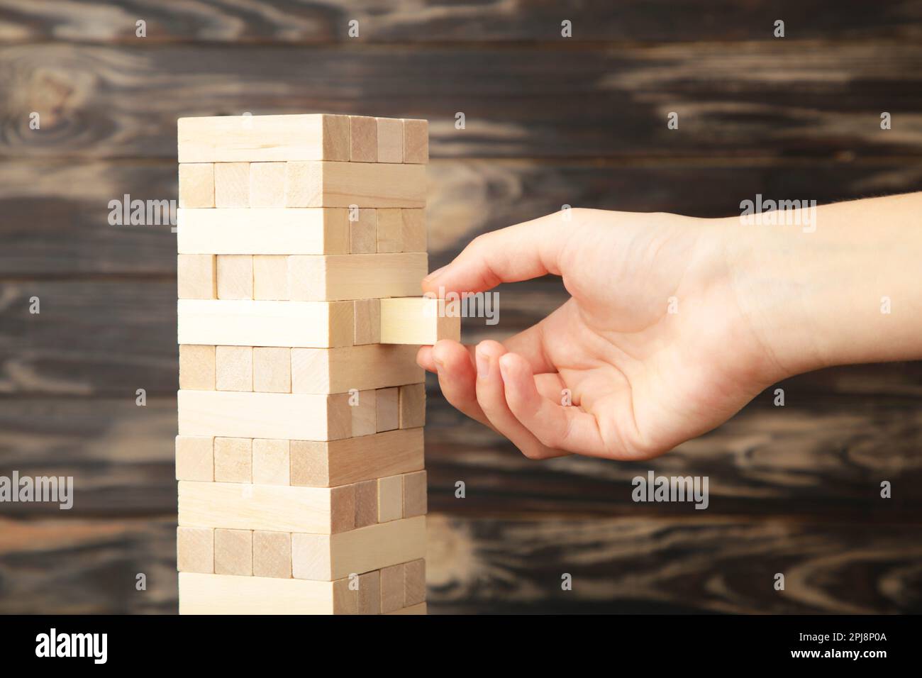 Business woman hand pick and put last piece block of the wood puzzle ...