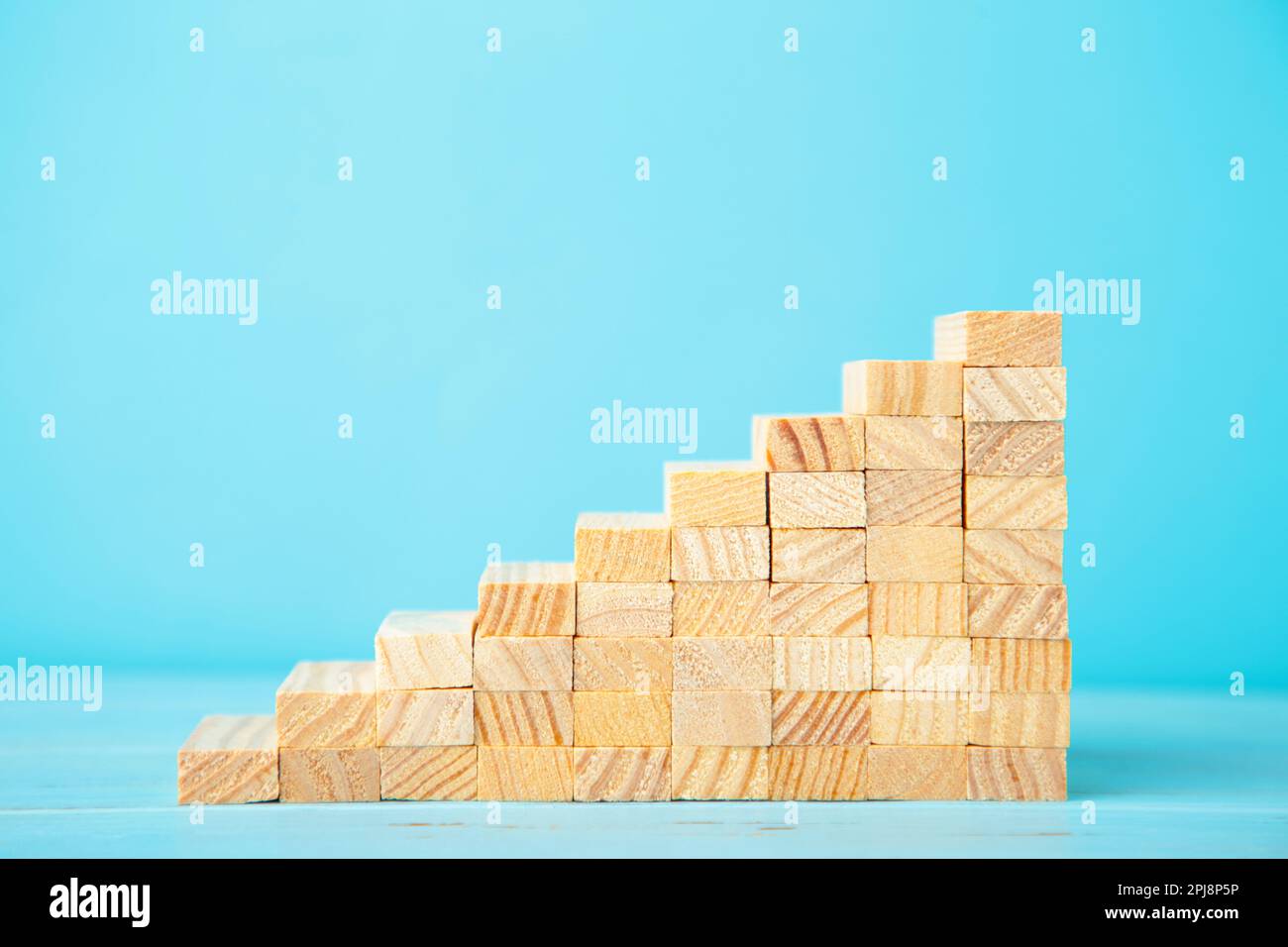 Blocks of wood on blue background. Business concept Stock Photo - Alamy