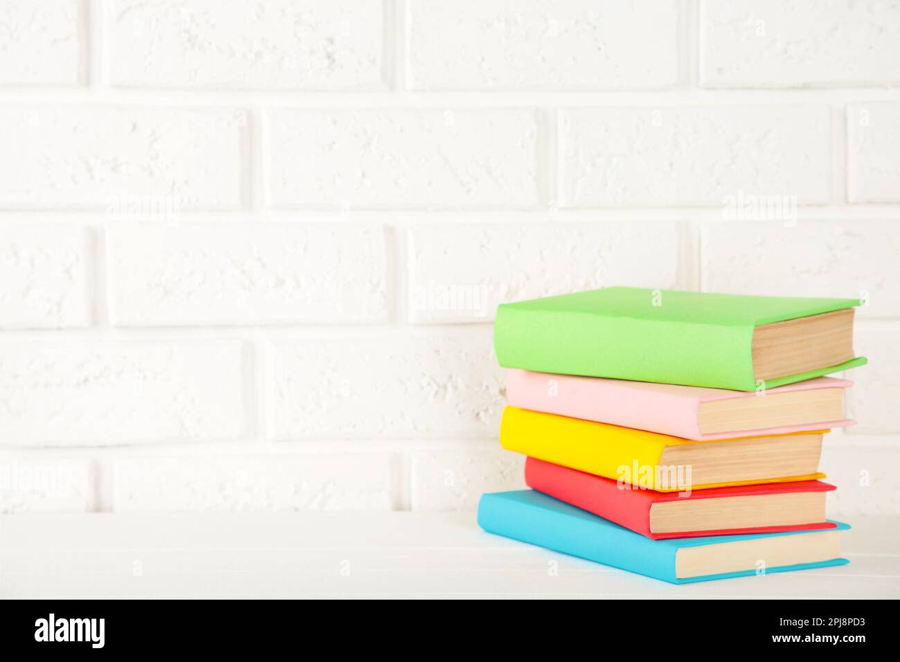 Multi coloured school books on a white background with copy space. Top view Stock Photo - Alamy